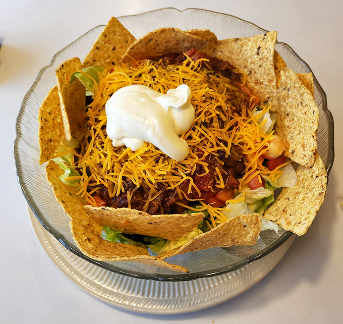 Taco salad that defies gravity &ndash; a crunchy, cheesy mountain of goodness topped with a cloud of sour cream.
