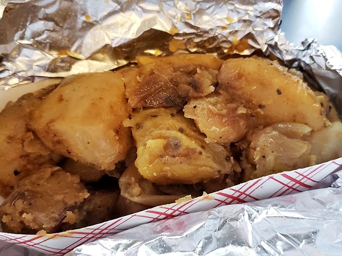 Golden-brown home fries that could make a potato farmer weep with joy, nestled in foil like the precious treasure they are.