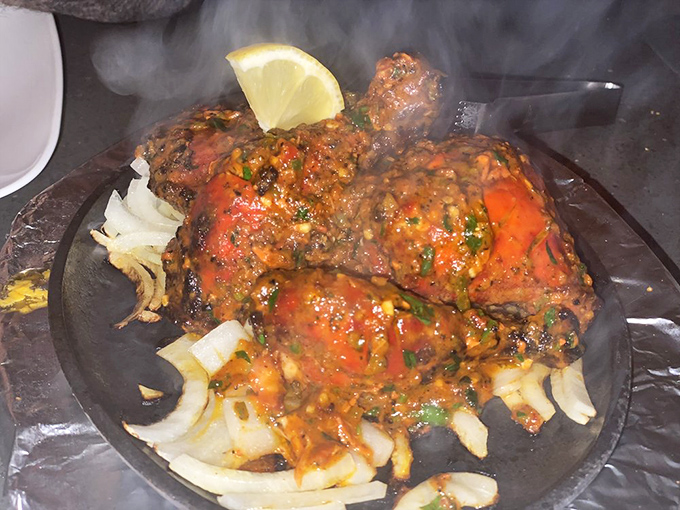 Tandoori chicken arrives sizzling like a Bollywood entrance, stealing every scene at your table.