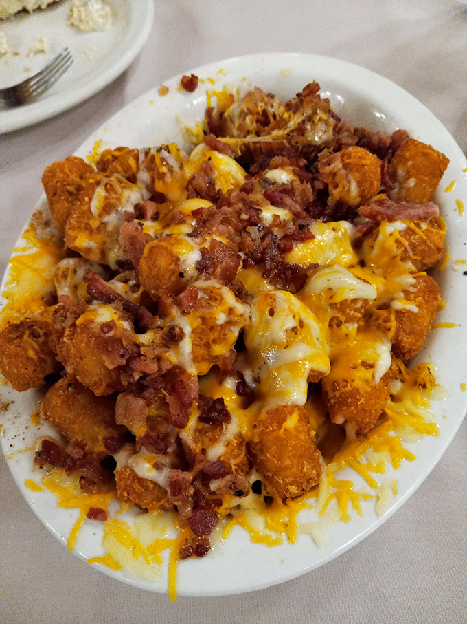 Golden tater tots elevated to art form with melted cheese and bacon. Proof that sometimes the best culinary innovations happen in small-town America.