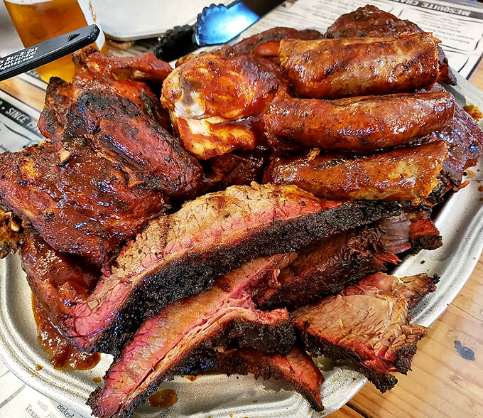 This isn't just a meat platter &ndash; it's a barbecue family reunion where ribs and brisket show off their smoke rings like proud badges of honor.