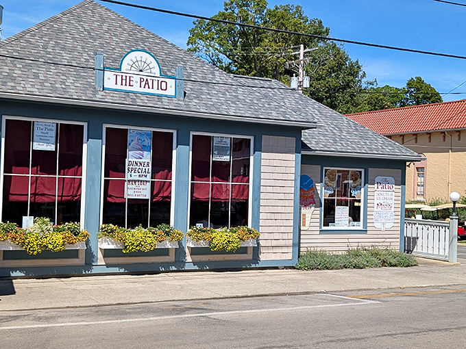 The Patio Restaurant promises lakeside dining with those cheerful yellow flower boxes setting the mood before you even taste the perch.