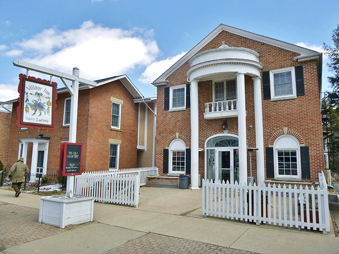 The Village Inn's colonial-inspired architecture houses comfort food that fuels both body and conversation. That white picket fence isn't just for show&mdash;it's containing culinary happiness.