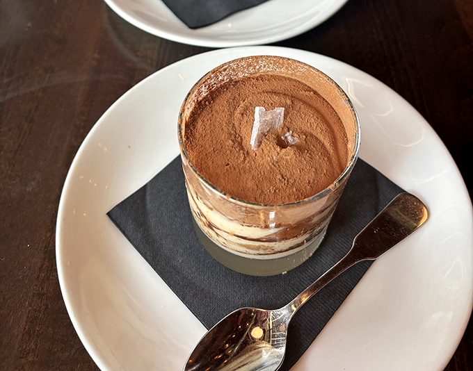 Tiramisu in a glass: where coffee, cocoa, and mascarpone perform a delicate ballet of flavors. Spoon required, sharing optional.