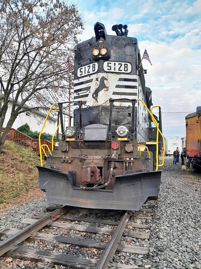 Engine 5128 stands ready for duty, its weathered face telling stories of countless journeys. The mechanical equivalent of Robert Redford&mdash;rugged and reliable.