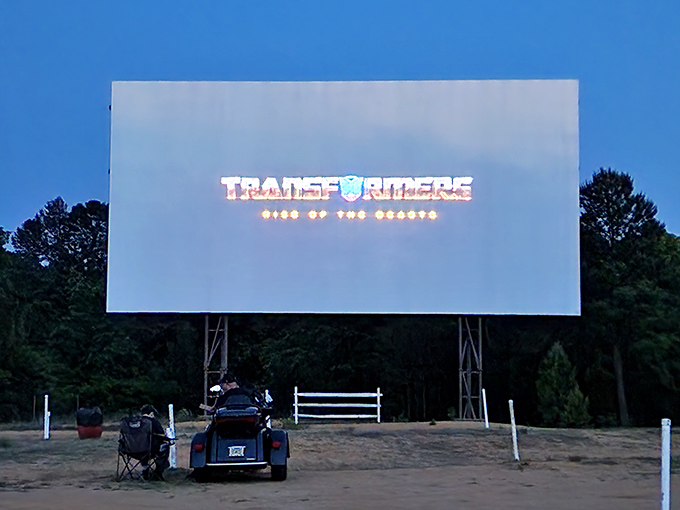"Transformers" lights up the massive screen as dusk settles. There's something magical about watching robots battle while fireflies compete for attention nearby.