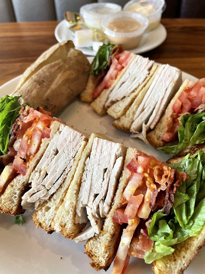 This isn't just a club sandwich&mdash;it's architecture. Layers of turkey, bacon, and fresh vegetables creating the skyscraper of sandwiches, with no permit required.
