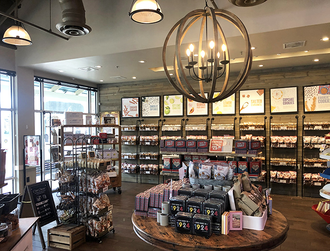 This specialty food shop doesn't just sell treats—it creates shopping sustenance. That spherical chandelier is practically saying, "Yes, you deserve that chocolate after three hours of retail therapy."