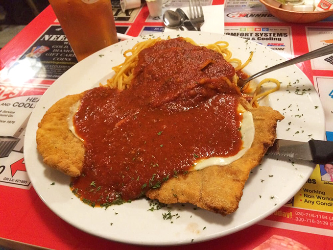 Veal parmesan that would make any Italian grandmother nod in approval. That golden-brown crust holding its own under a blanket of rich tomato sauce.