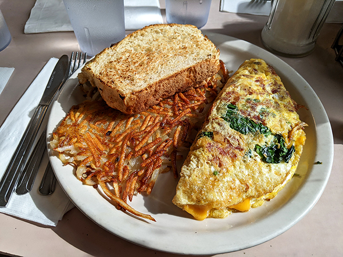 Breakfast perfection on a plate. The omelet arrives with crispy hash browns and toast &ndash; the holy trinity of morning satisfaction.