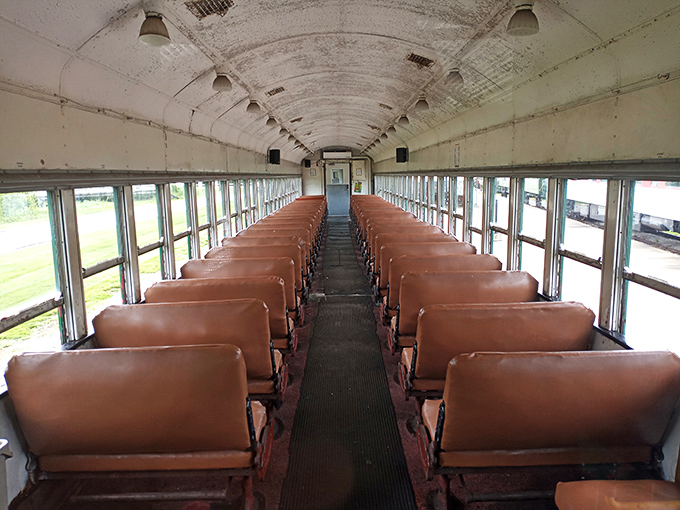 Rows of burnished leather seats await passengers in this meticulously preserved coach car, where every detail whispers of 1940s travel elegance.