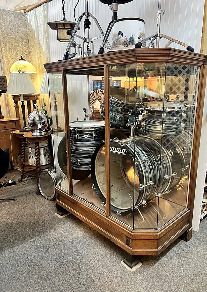 A vintage drum kit preserved behind glass like a rock and roll time capsule. Somewhere, a 1960s garage band is missing their heartbeat.