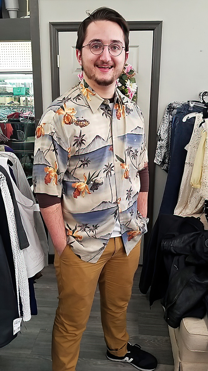 The image shows a shopper in the clothing section, where vintage Hawaiian shirts and other fashion finds await their next adventure.