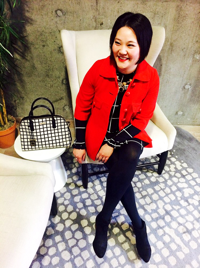 The image shows a stylish visitor enjoying the comfortable seating area, showcasing how thrifted fashion can look absolutely fabulous.