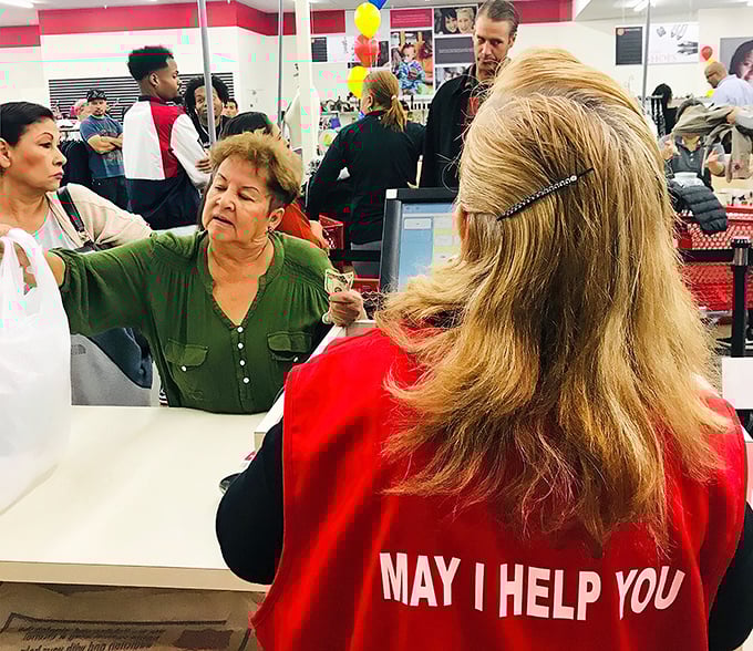 Staff in their signature "May I Help You" vests create the human connection that makes thrifting more than just shopping.