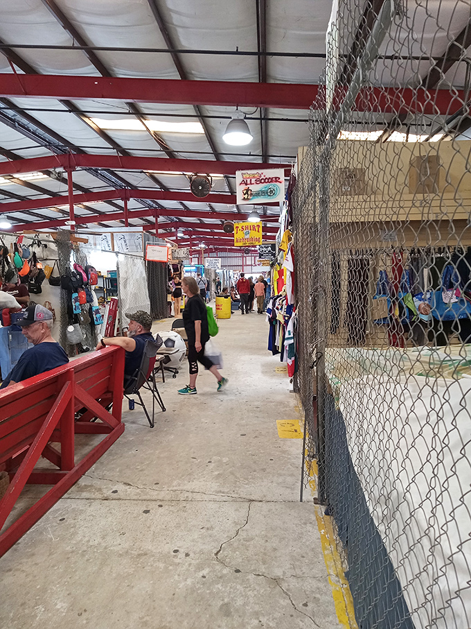 Red beams frame the indoor market's maze of merchandise, where serious shoppers navigate with the focus of treasure hunters.