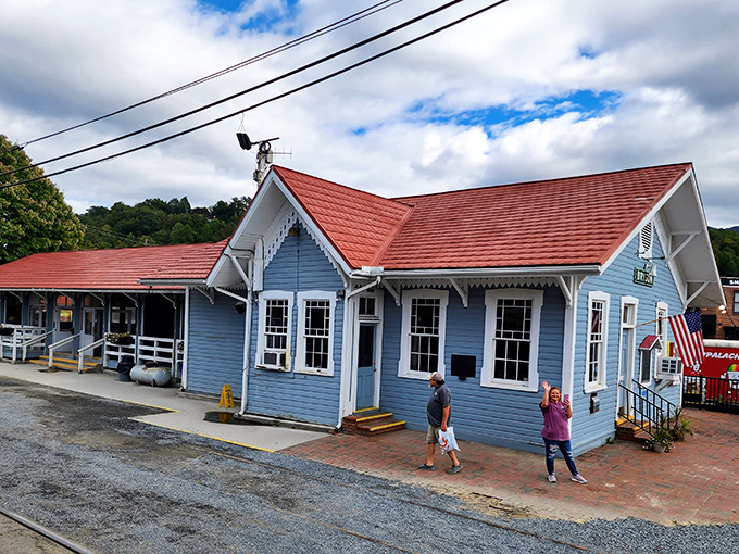Charming blue depot straight from a storybook. This historic station serves as the gateway to mountain adventures for excited travelers.