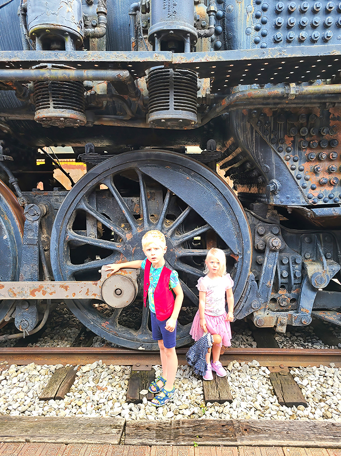 The intricate machinery of locomotion revealed: massive wheels and connecting rods that transformed steam power into forward motion.