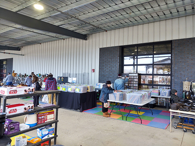 Vinyl enthusiasts in their natural habitat, flipping through records with practiced precision. The hunt for that rare album is serious business here.