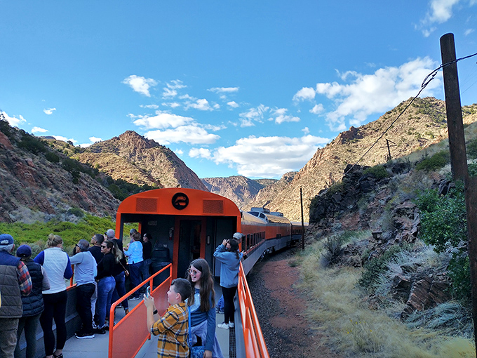 The open-air car offers the ultimate viewing experience—where else can you feel the canyon breeze while safely hanging off the side of a moving train?