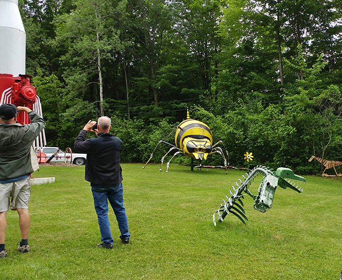 Visitors capture memories of metallic monsters, where dinosaurs and spiders become the stars of family vacation albums instead of the usual landmarks.