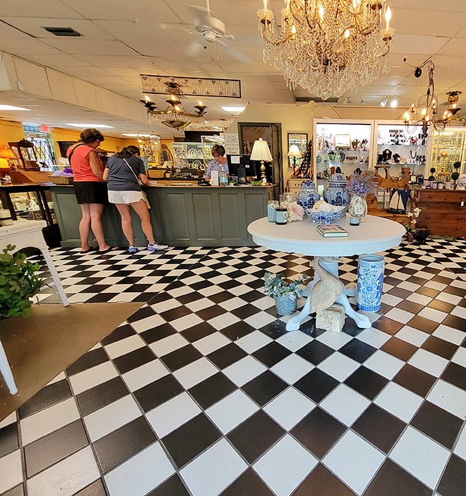 The check-out counter buzzes with activity while blue and white porcelain creates a striking focal point. That chandelier has likely illuminated decades of dinner parties.
