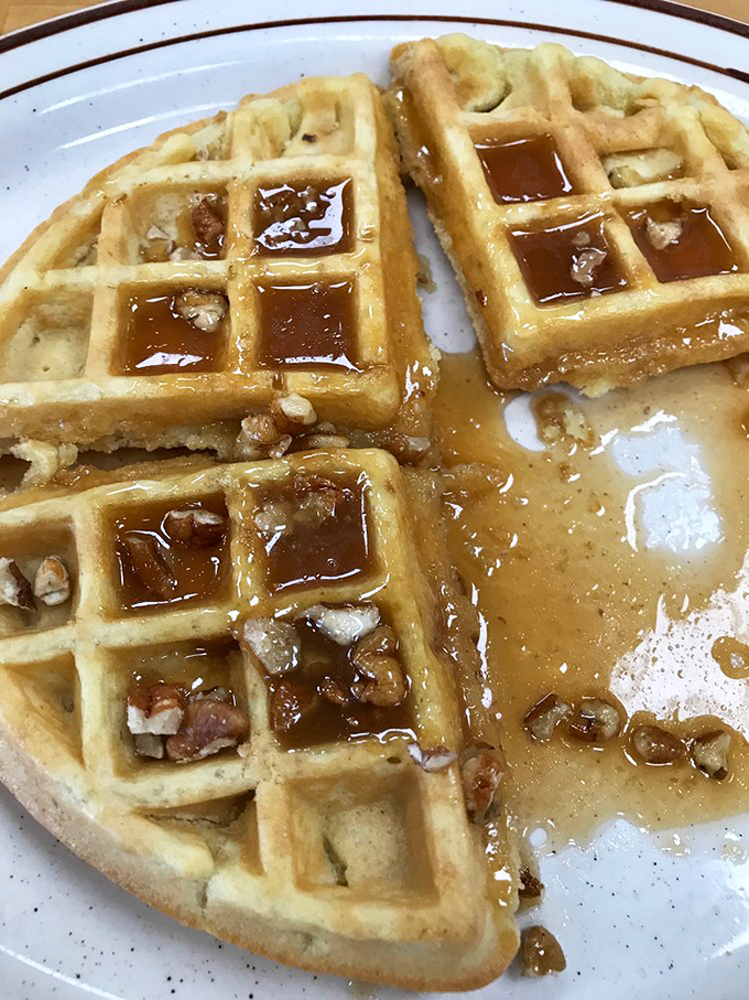 These golden waffles with pecans and syrup puddles aren't just breakfast&mdash;they're edible sunshine on a plate.