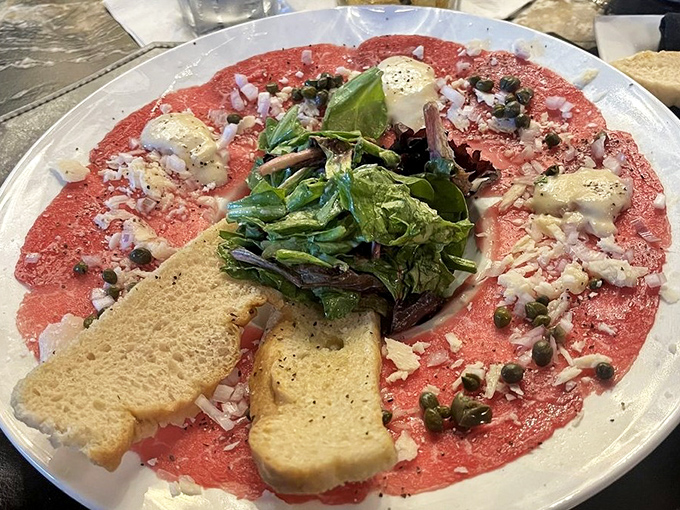 Carpaccio so delicately sliced you could read the wine list through it, adorned with capers that pop like tiny flavor grenades.