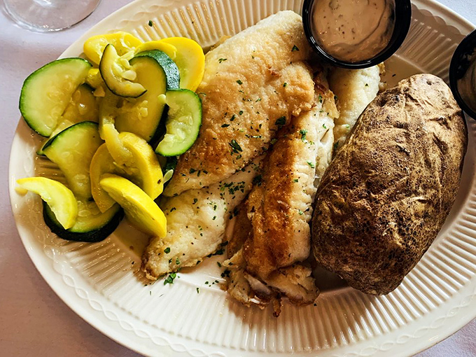 Lake Superior walleye, the Midwest's answer to coastal seafood snobbery. Flaky, delicate, and served with summer squash and a baked potato worthy of its own fan club.