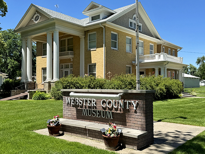 The Webster County Museum's grand columns say "important history inside" while the wraparound porch whispers "stay awhile, let's chat."