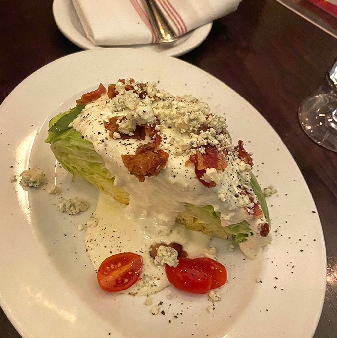 The wedge salad&mdash;that steakhouse classic&mdash;gets the royal treatment with crisp lettuce, creamy dressing, and bacon bits that should be classified as currency.