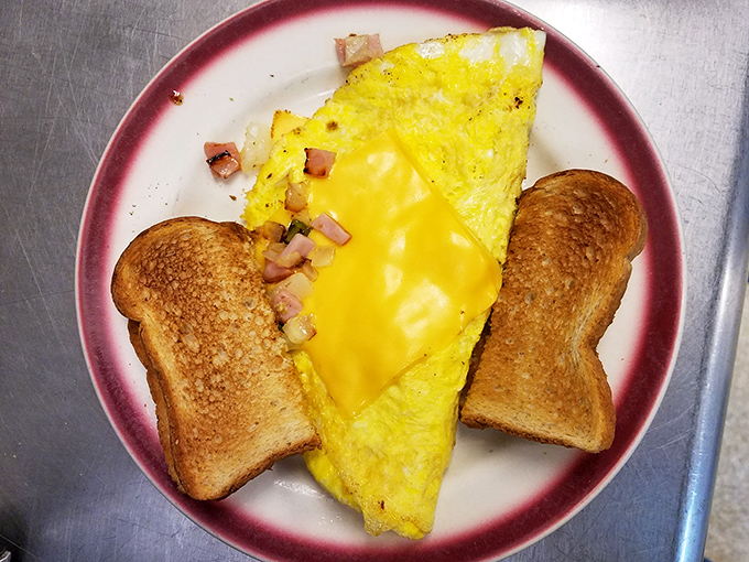 This cheese-laden omelet isn't just breakfast&mdash;it's edible sunshine on a plate, flanked by toast soldiers ready for yolk-dipping duty.