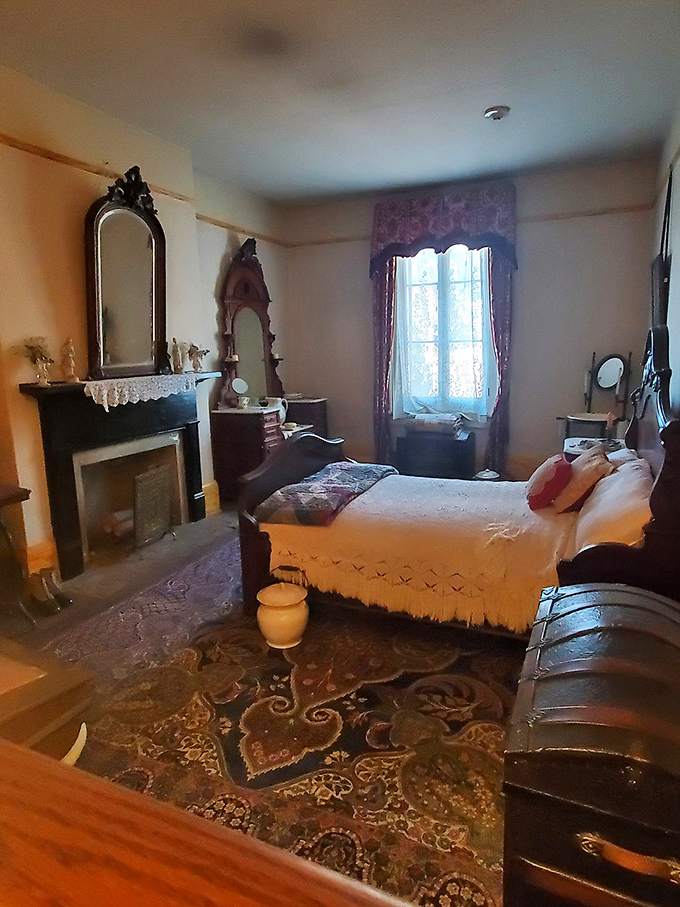 Antique beds and Victorian decor create an atmosphere that's equal parts museum display and supernatural headquarters.