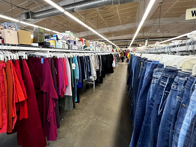 The clothing aisles stretch toward the horizon like a textile Grand Canyon, with denim on one side and every color imaginable on the other.