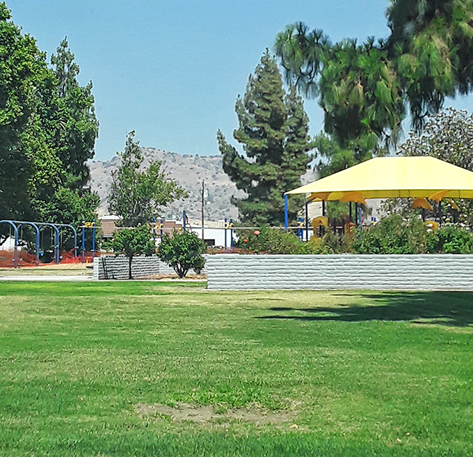 This neighborhood park offers the perfect antidote to screen time&mdash;actual sunshine, real grass, and yellow shade structures that say "stay awhile" in the universal language of comfort.