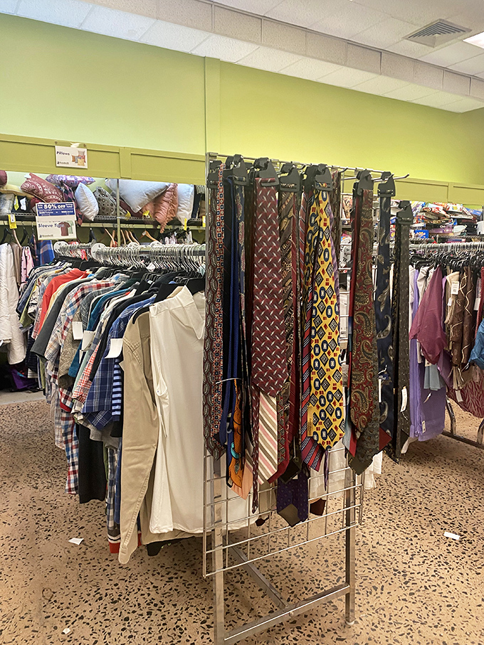 The necktie display resembles a colorful textile waterfall, where corporate castoffs find new life with budget-conscious professionals.