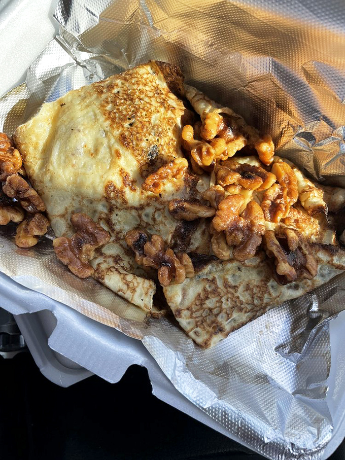 The star of the show: apple walnut crepes that achieve that perfect balance of crisp edges and tender center. Time stops when that first forkful hits your palate.