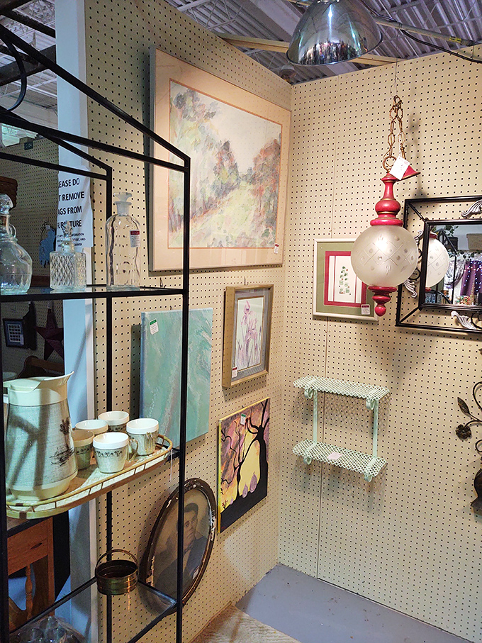 This art and décor booth combines vintage paintings, delicate glassware, and a stunning hanging lamp—a decorator's dream in one cozy corner.