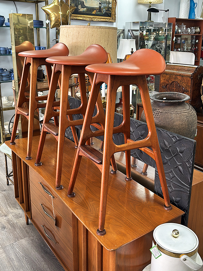 These sculptural bar stools with their warm teak and saddle-shaped seats are practically begging for martini hour to make a comeback.