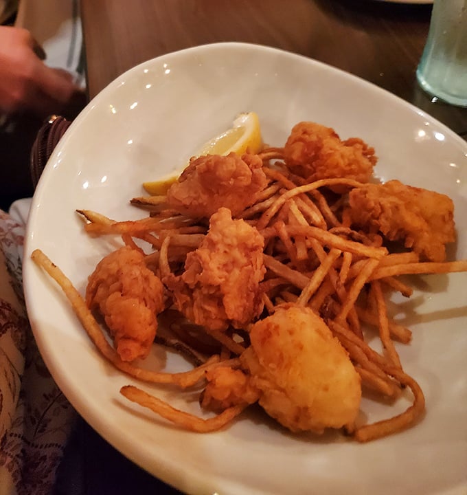 Whoever decided to batter and fry lobster deserves a Nobel Prize. These golden morsels perched atop crispy shoestrings are Midwest ingenuity at its finest.