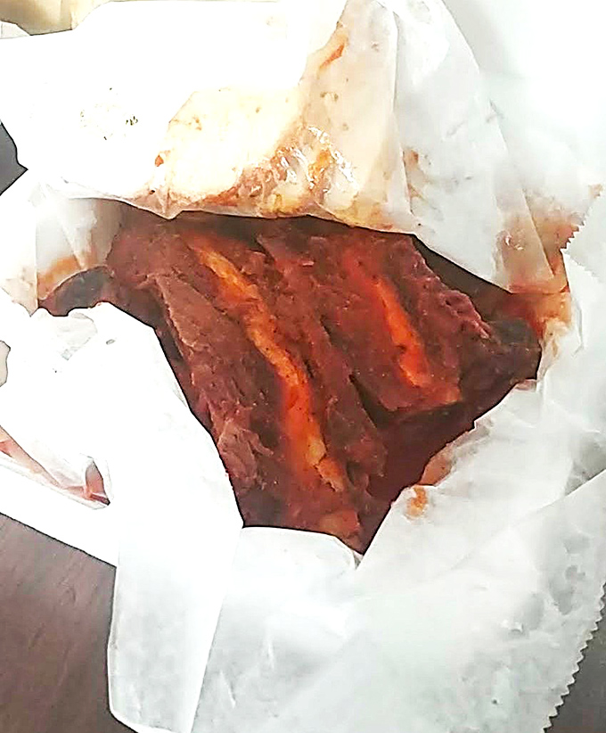 Behold the beef ribs in their paper-wrapped glory. That smoke ring isn't just for show &ndash; it's a pink badge of honor.