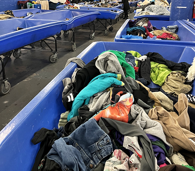 These blue bins aren't just containers&mdash;they're portals to possibility. Somewhere in this textile mountain lurks a cashmere sweater with your name on it.