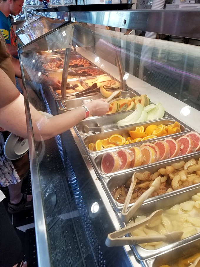 The breakfast buffet's colorful array makes decision-making harder than choosing which beach to visit first.