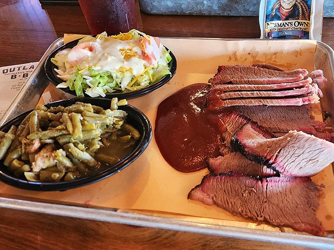 Brisket so perfectly sliced you could read a newspaper through it, with a bark that deserves its own standing ovation.