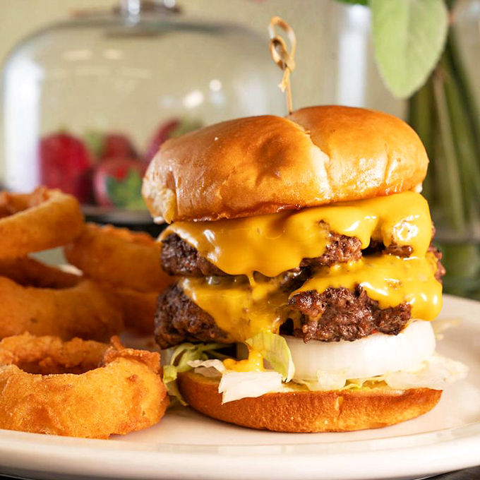 This isn't just a cheeseburger; it's a towering monument to the art of proper diner indulgence, complete with crispy onion rings.
