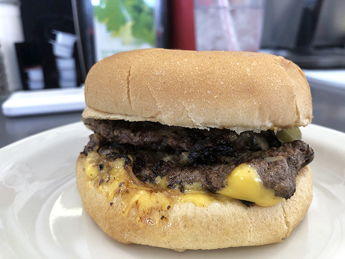 The star of the show in all its glory. This isn't some architectural burger fantasy—it's the real deal, where cheese meets beef in perfect harmony.