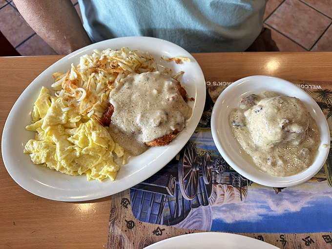 Country-fried steak smothered in gravy alongside scrambled eggs&mdash;comfort food that makes you want to hug your plate before devouring every last morsel.