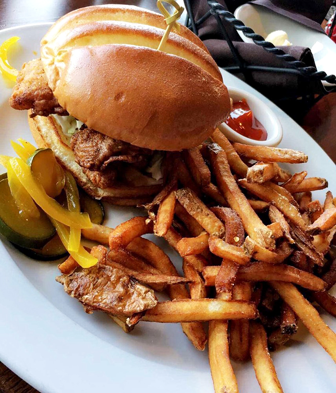 Not just a sandwich, but an architectural masterpiece of golden-fried goodness and hand-cut fries that would make any lunch break feel like vacation.