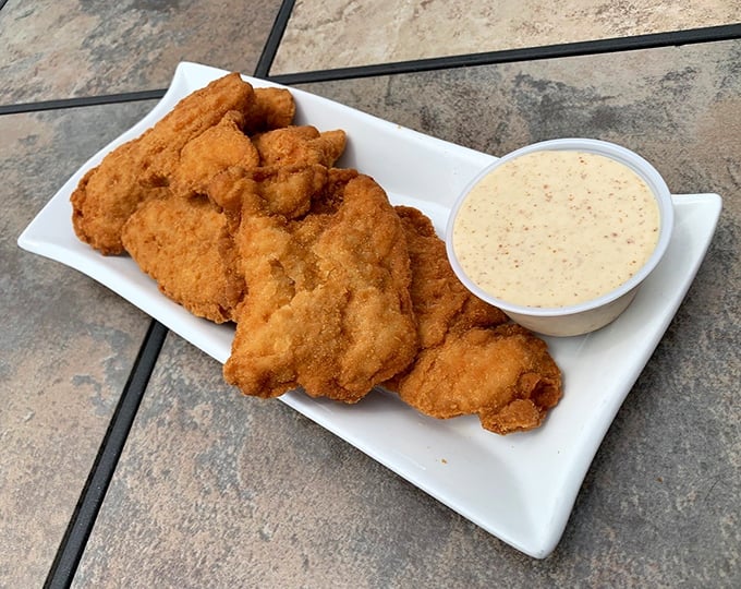 Golden-fried chicken tenders that shatter with a satisfying crunch, paired with a dipping sauce worth bottling and taking home.