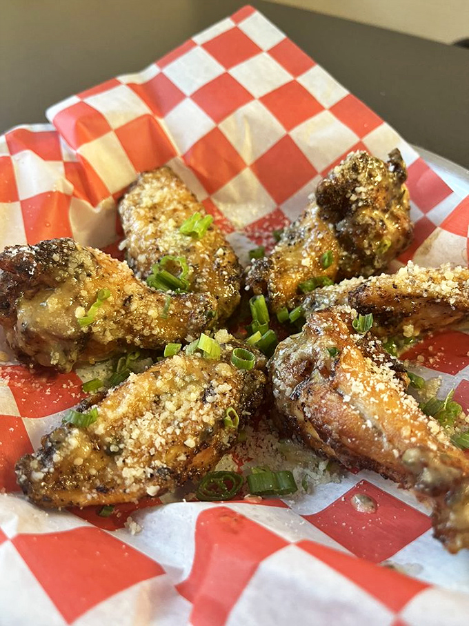 These aren't just wings; they're parmesan-dusted flavor bombs. The green onion garnish adds a fresh pop to each savory bite.